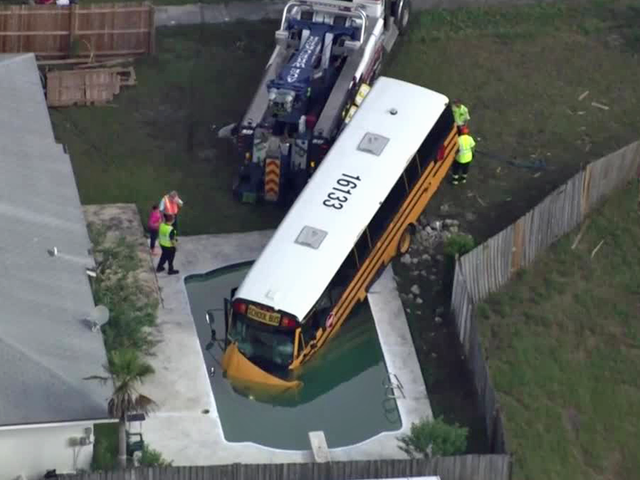 Florida school bus plunges into swimming pool - wptv.com